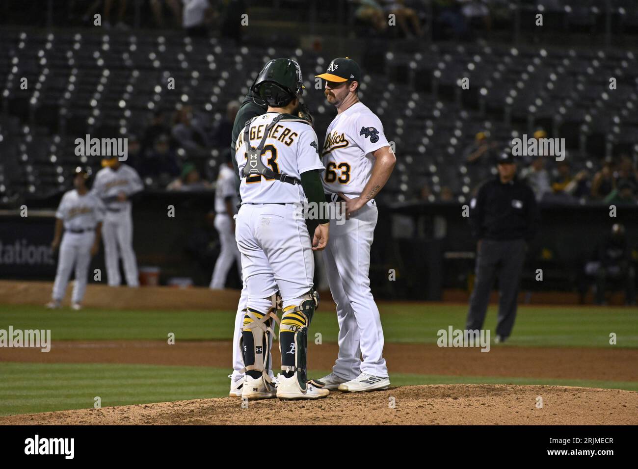 Oakland Athletics catcher Shea Langeliers (23) talks with pitcher Hogan ...