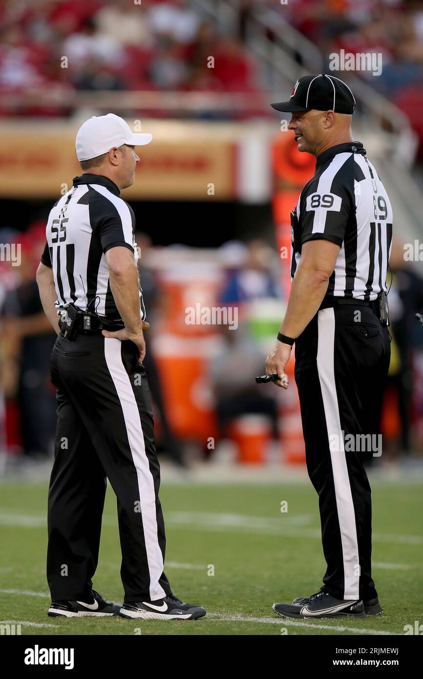 Referee Alex Kemp (55) and Umpire Mike Morton (89) talk on the field ...