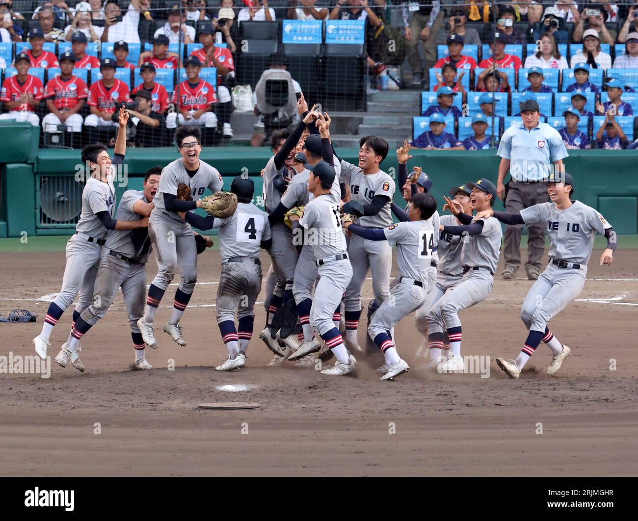 Members of Keio Senior High School Baseball Club react after winning ...