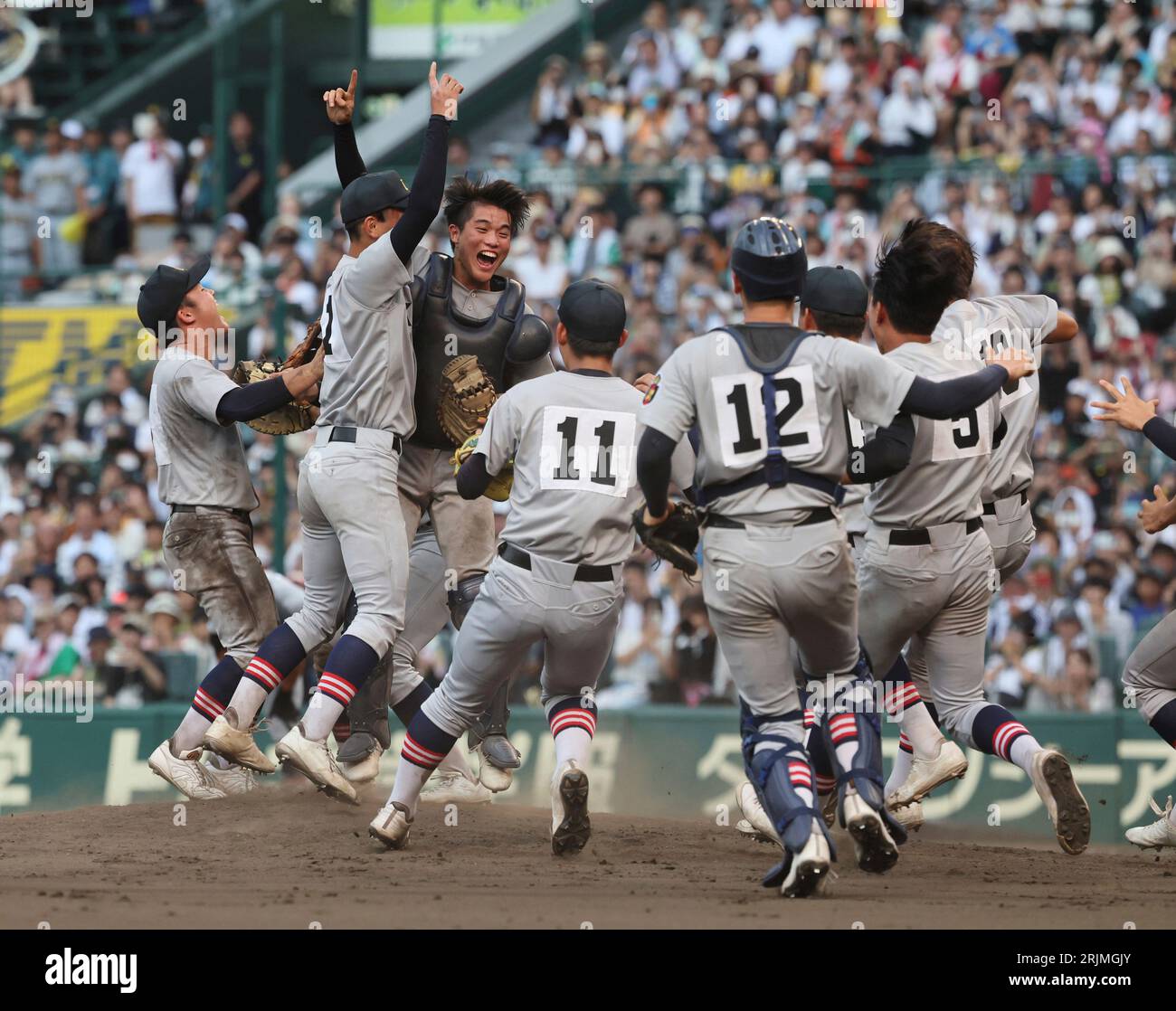 Members of Keio Senior High School Baseball Club react after winning ...