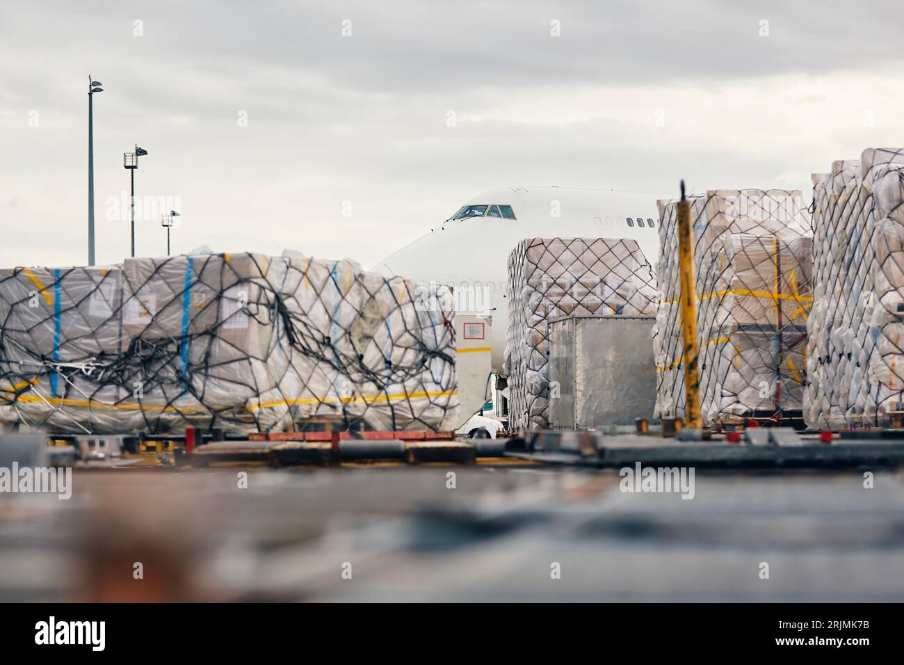 Preparation freight airplane before flight. Loading of cargo containers ...