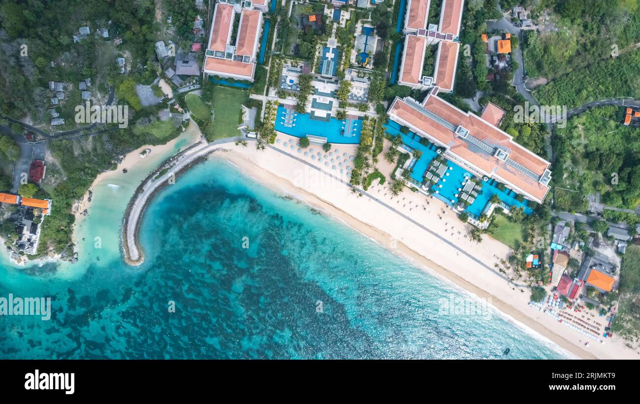 An aerial view of a waterfront area featuring several hotels and ...