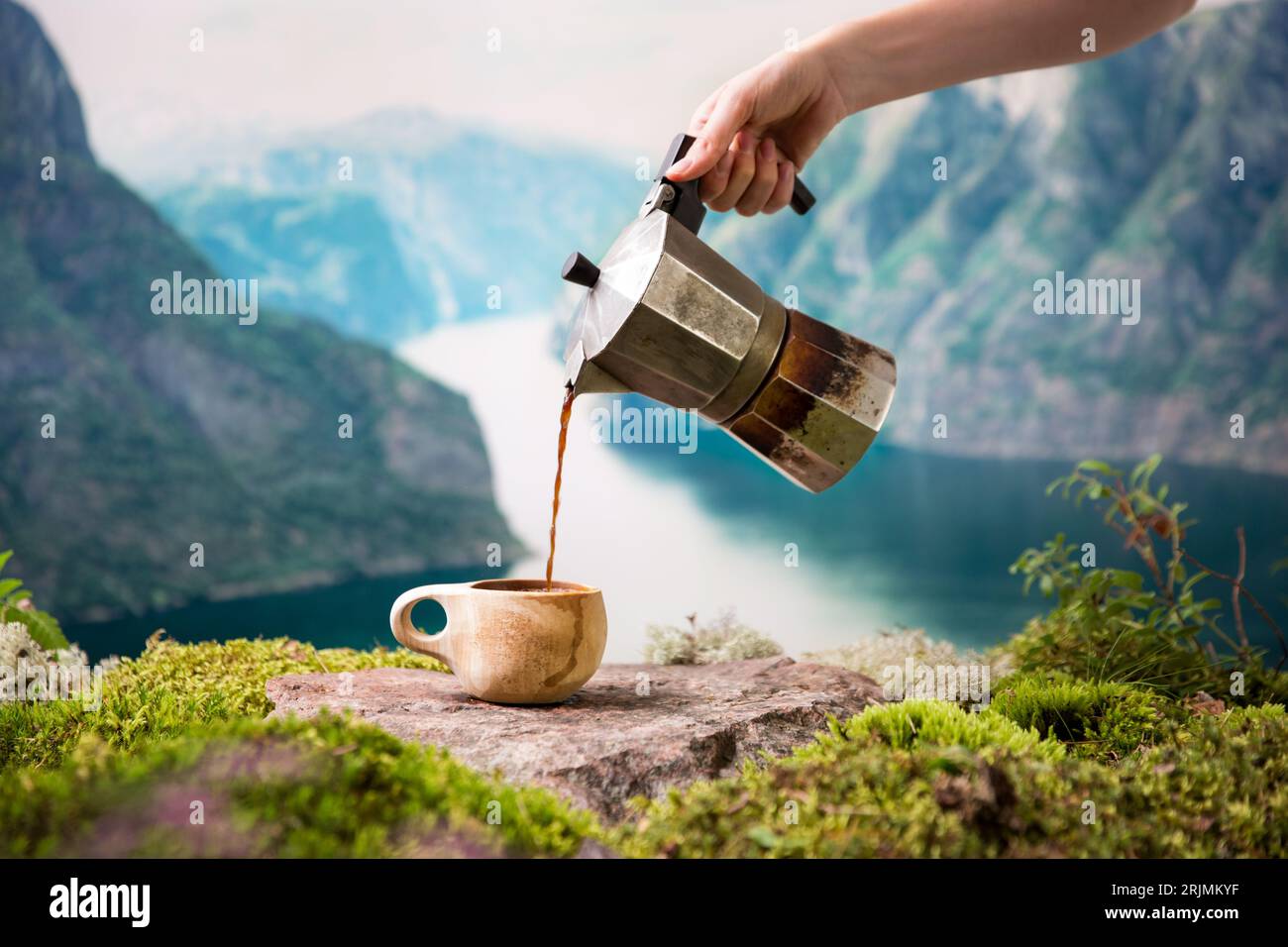 Woman tourist backpacker pouring coffee from a moka coffee maker into a ...