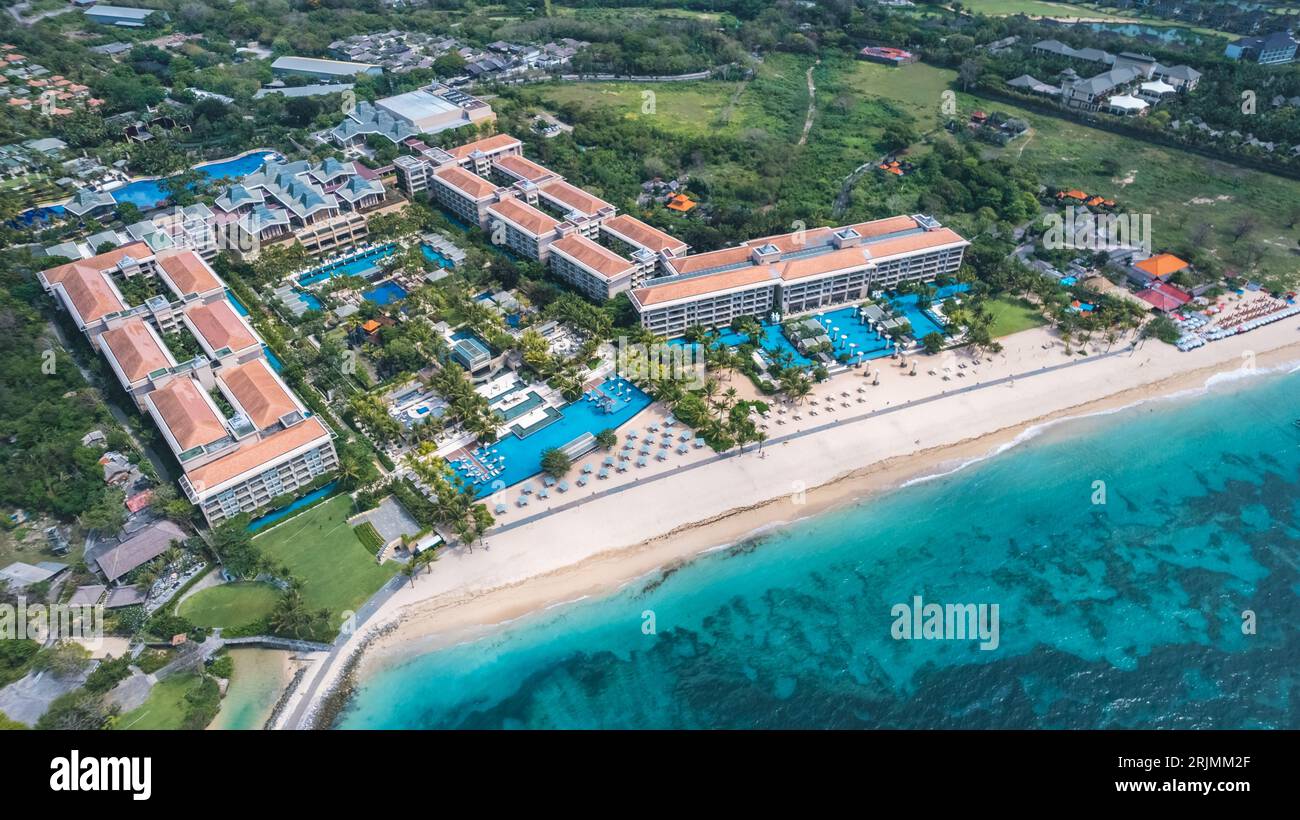 An aerial view of a waterfront area featuring several hotels and ...