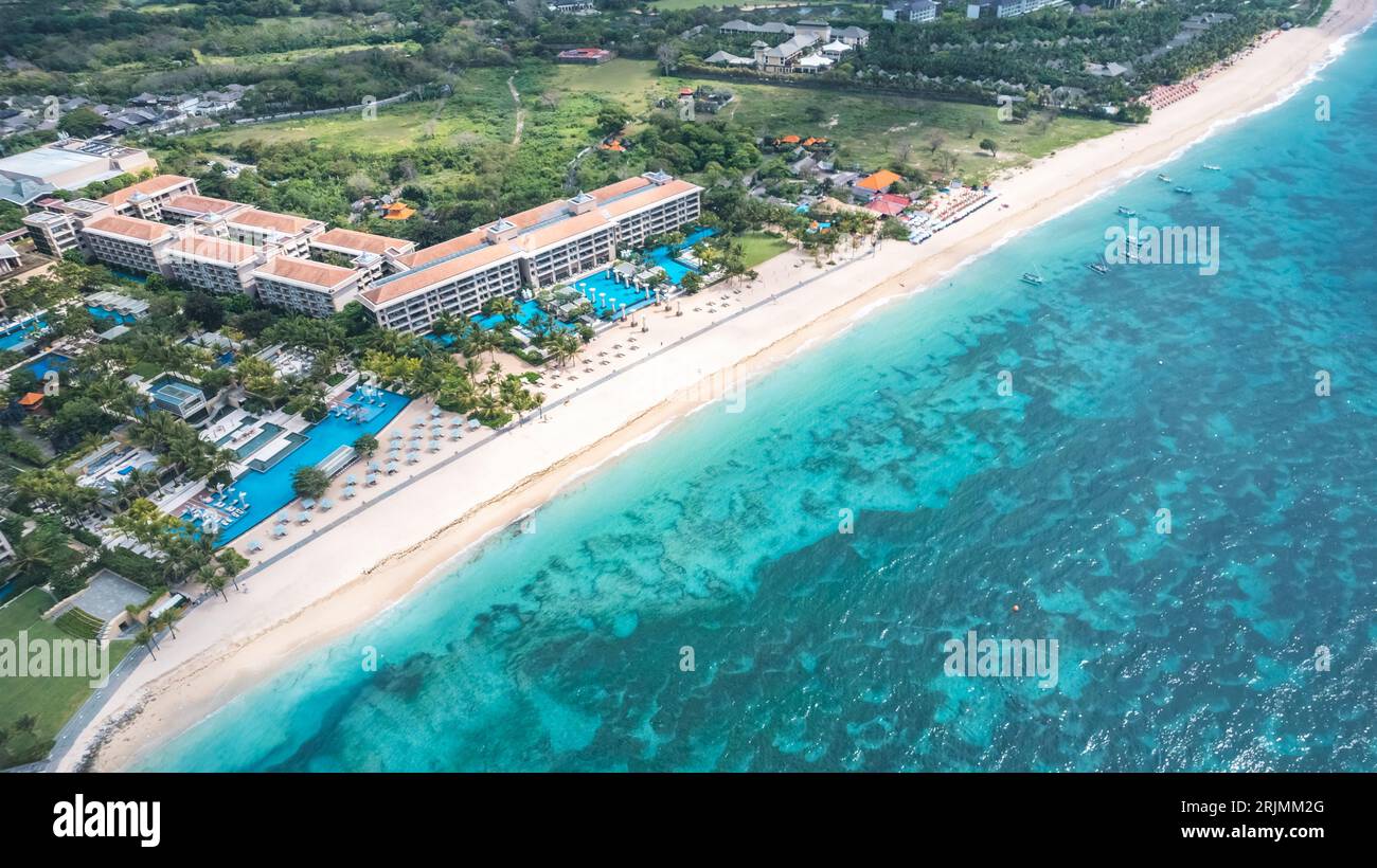 An aerial view of a waterfront area featuring several hotels and ...