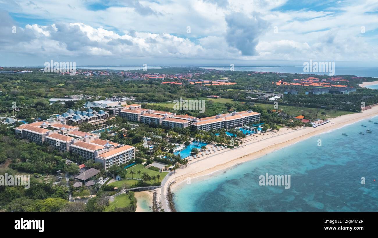 An aerial view of a waterfront area featuring several hotels and ...