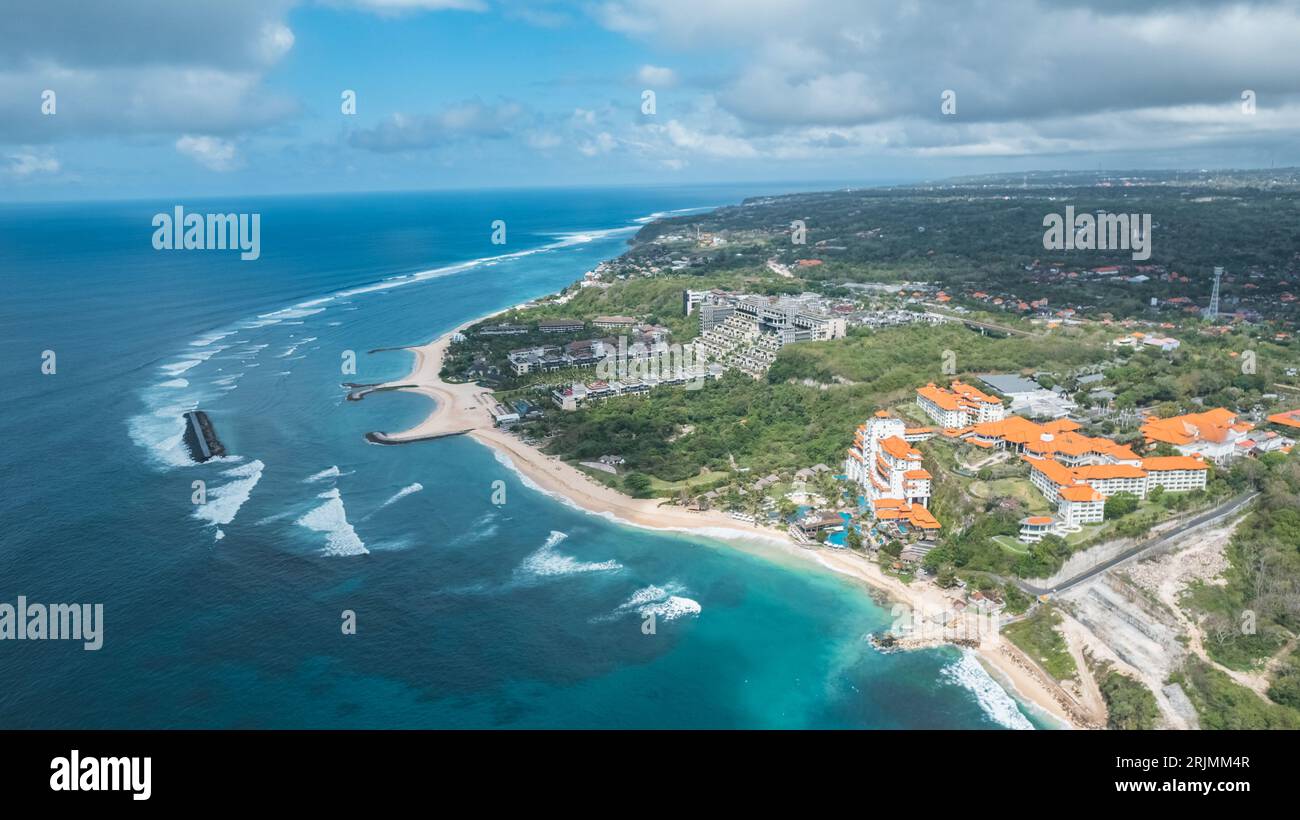 An aerial view of a waterfront area featuring several hotels and ...