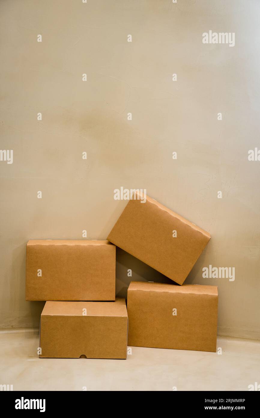 A pile of cardboard boxes arranged in a stack on a beige colored ...