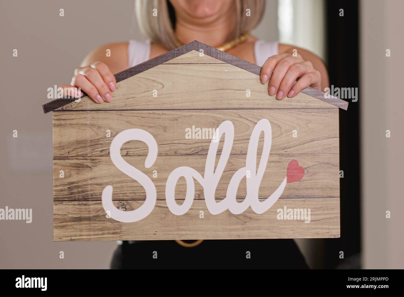 Female realtor holding sold sign hi-res stock photography and images ...