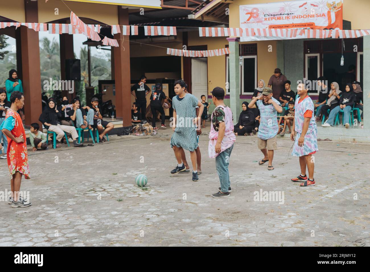 Men playing soccer competition wearing negligee celebrating Indonesia's ...