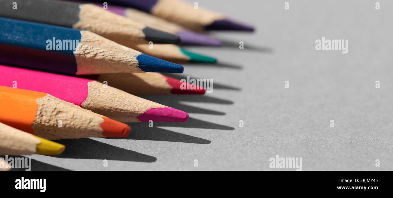 Set of colored pencils on grey table Stock Photo - Alamy