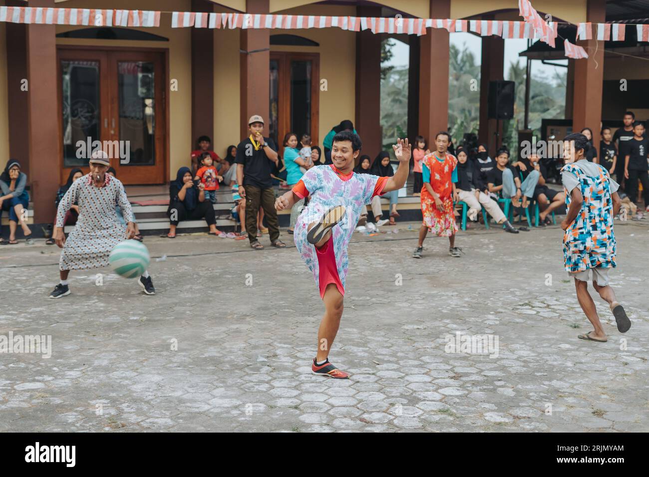 Men playing soccer competition wearing negligee celebrating Indonesia's ...