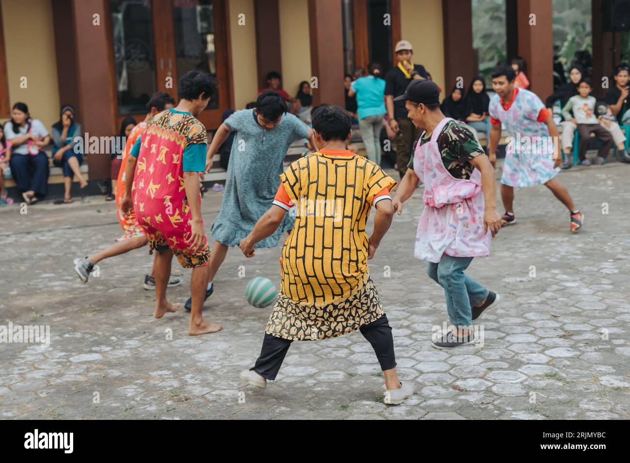 Men playing soccer competition wearing negligee celebrating Indonesia's ...