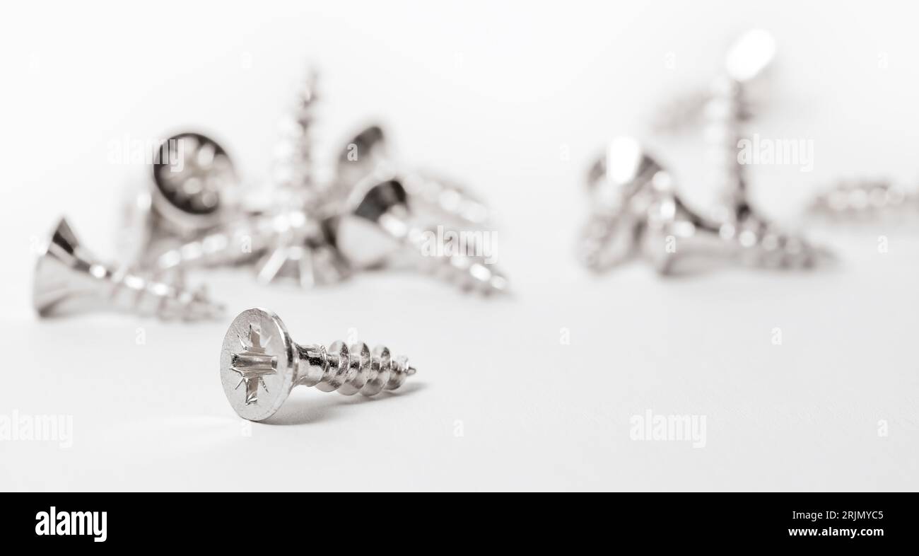 Metal screws scattered, industrial background. Steel screws, metal ...