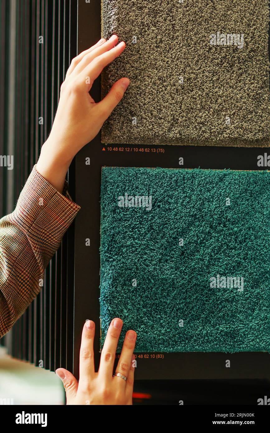 Close up woman hand chooses a carpet in a hardware store Stock Photo ...