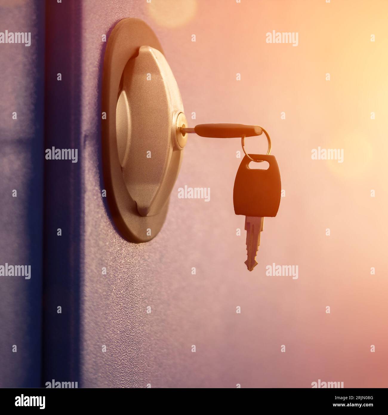 Home keys in keyhole under sunlight Stock Photo - Alamy