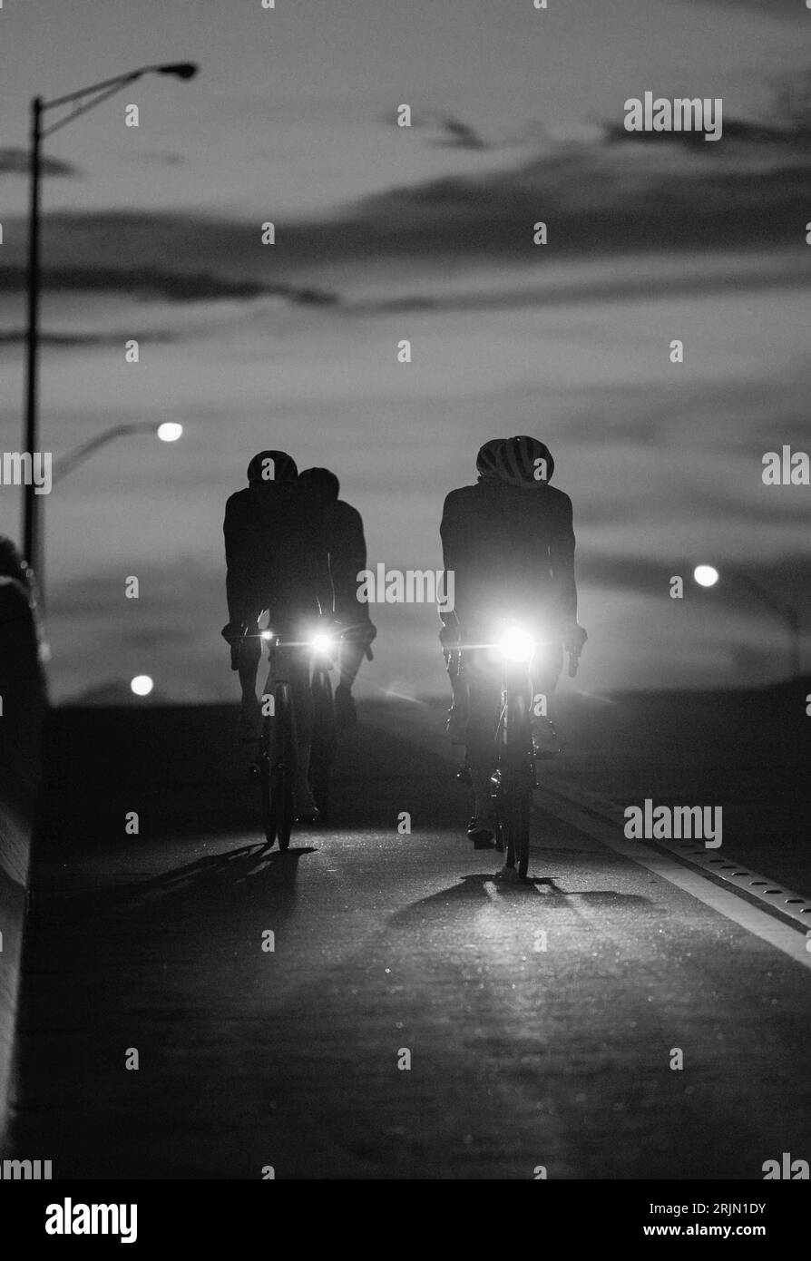 Two people biking in Black and White Stock Photos & Images - Alamy