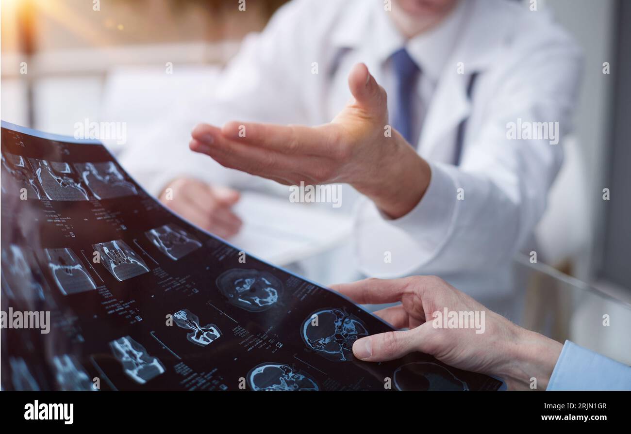 shows the x-ray image to the patient at the reception Stock Photo - Alamy