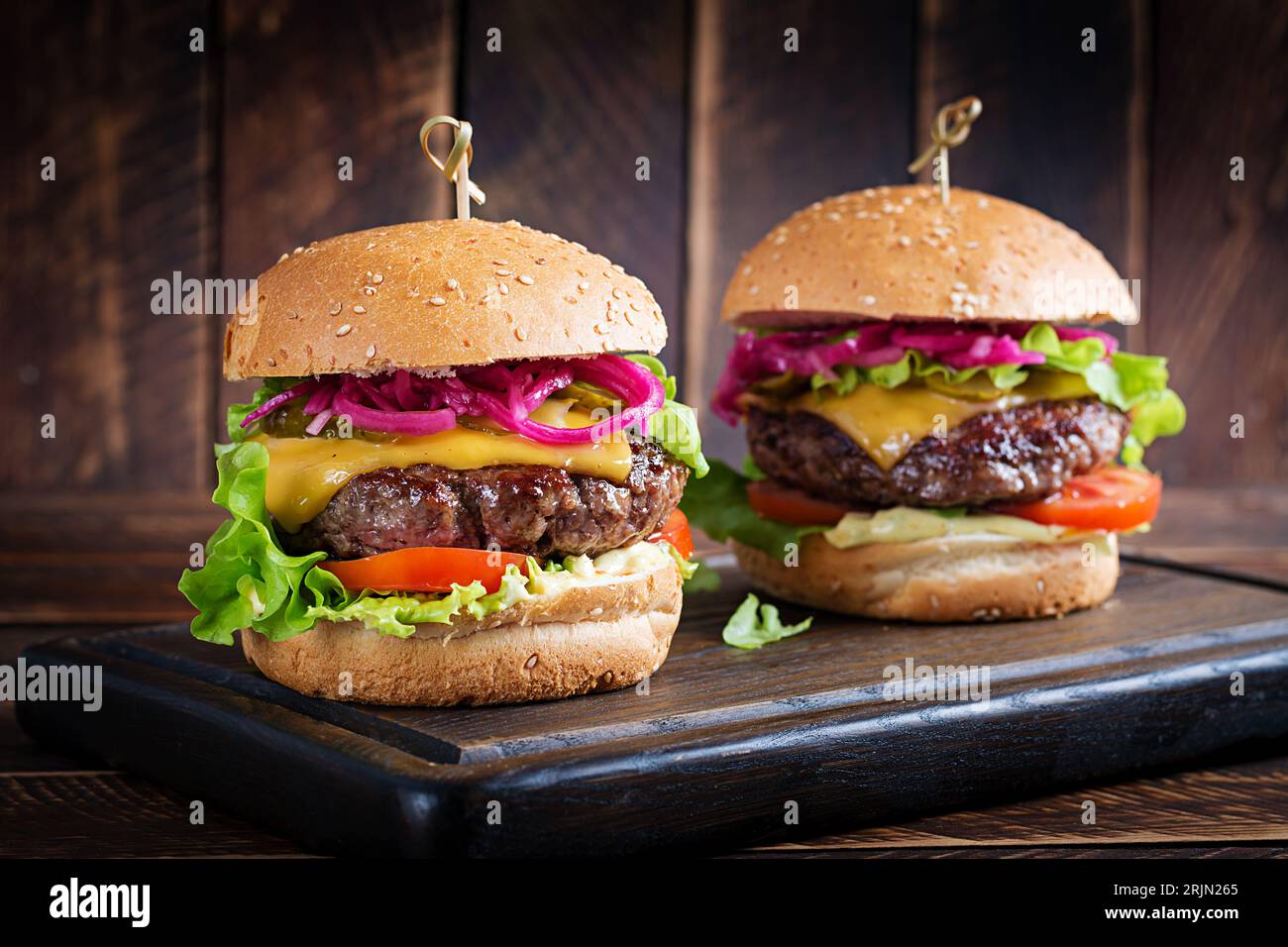 Beef hamburger. Sandwich with beef burger, tomatoes, cheese, pickled cucumber and lettuce ...