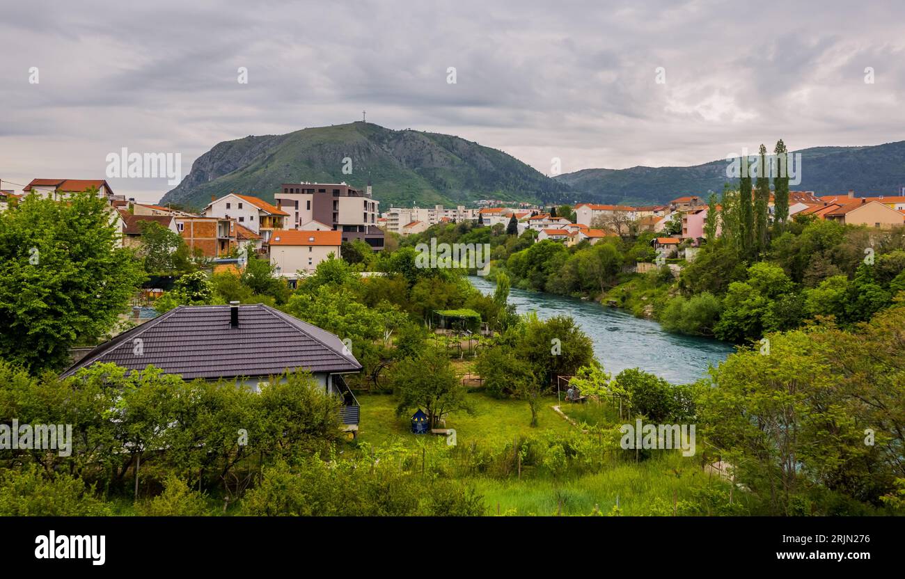 An aerial view of a quaint, small-town nestled between mountain ranges ...