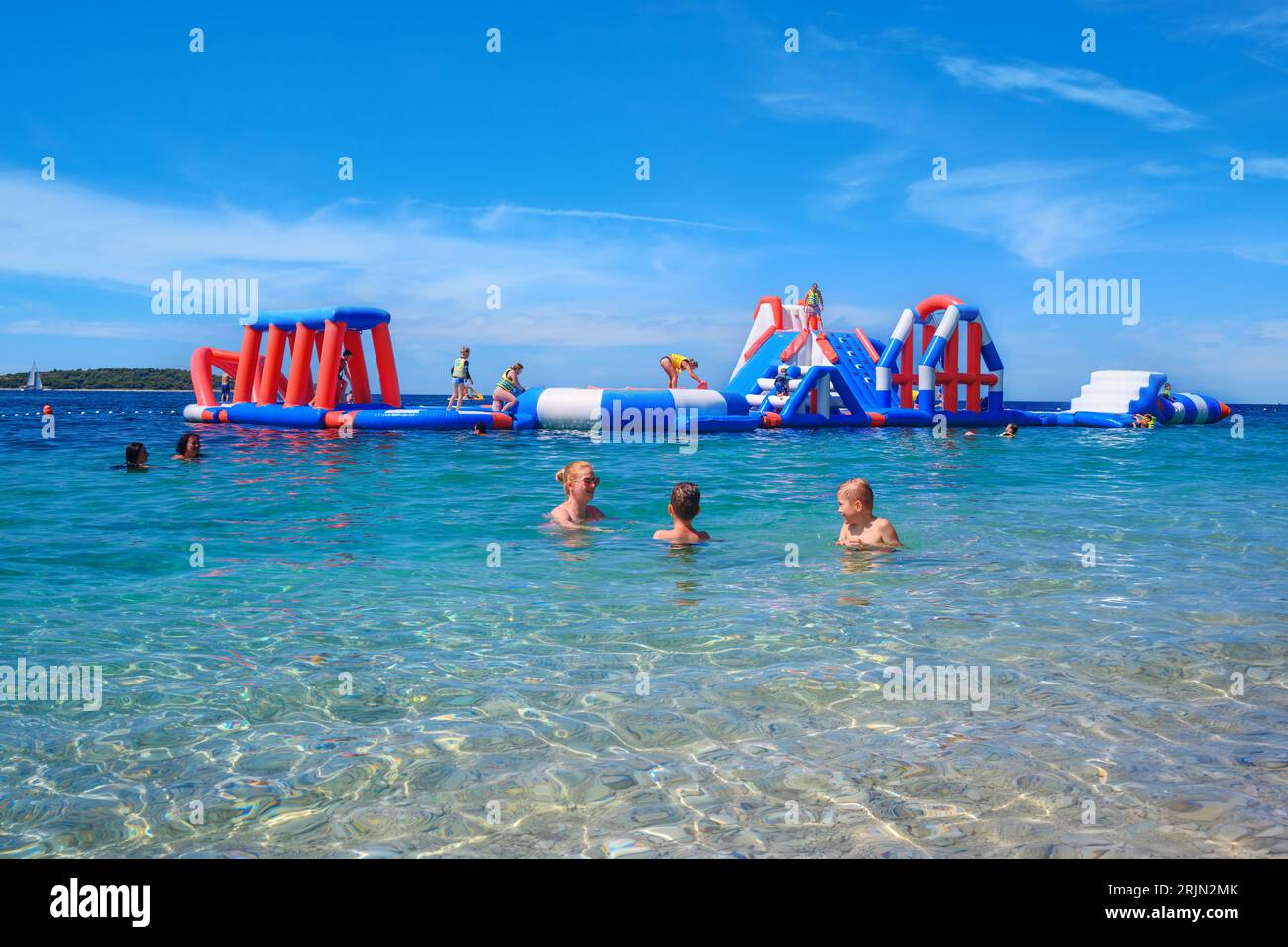 People on an inflatable water attraction Stock Photo - Alamy
