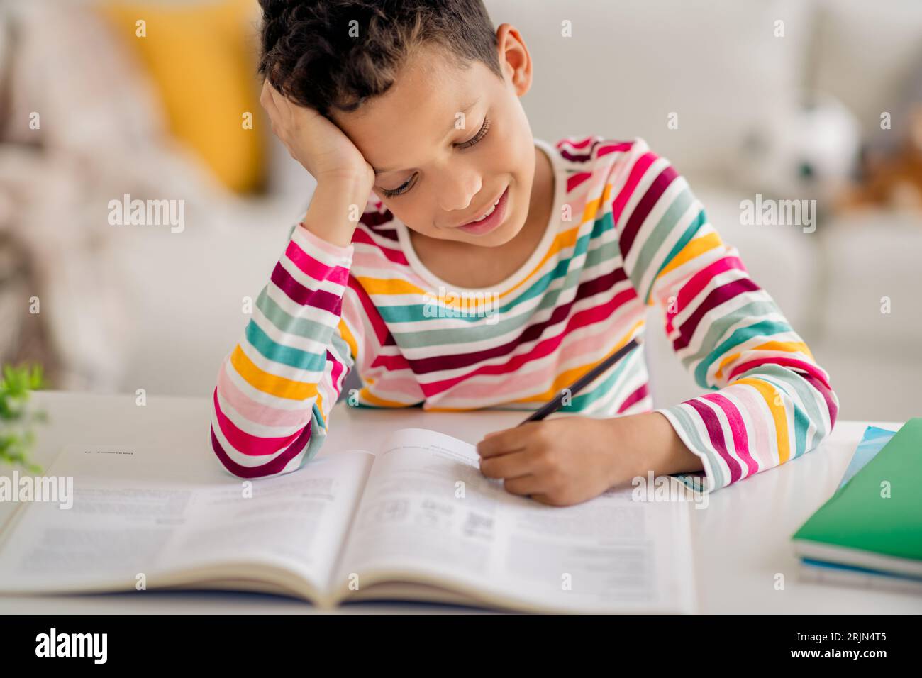 Photo of young miniature little preschool boy writing book discover ...