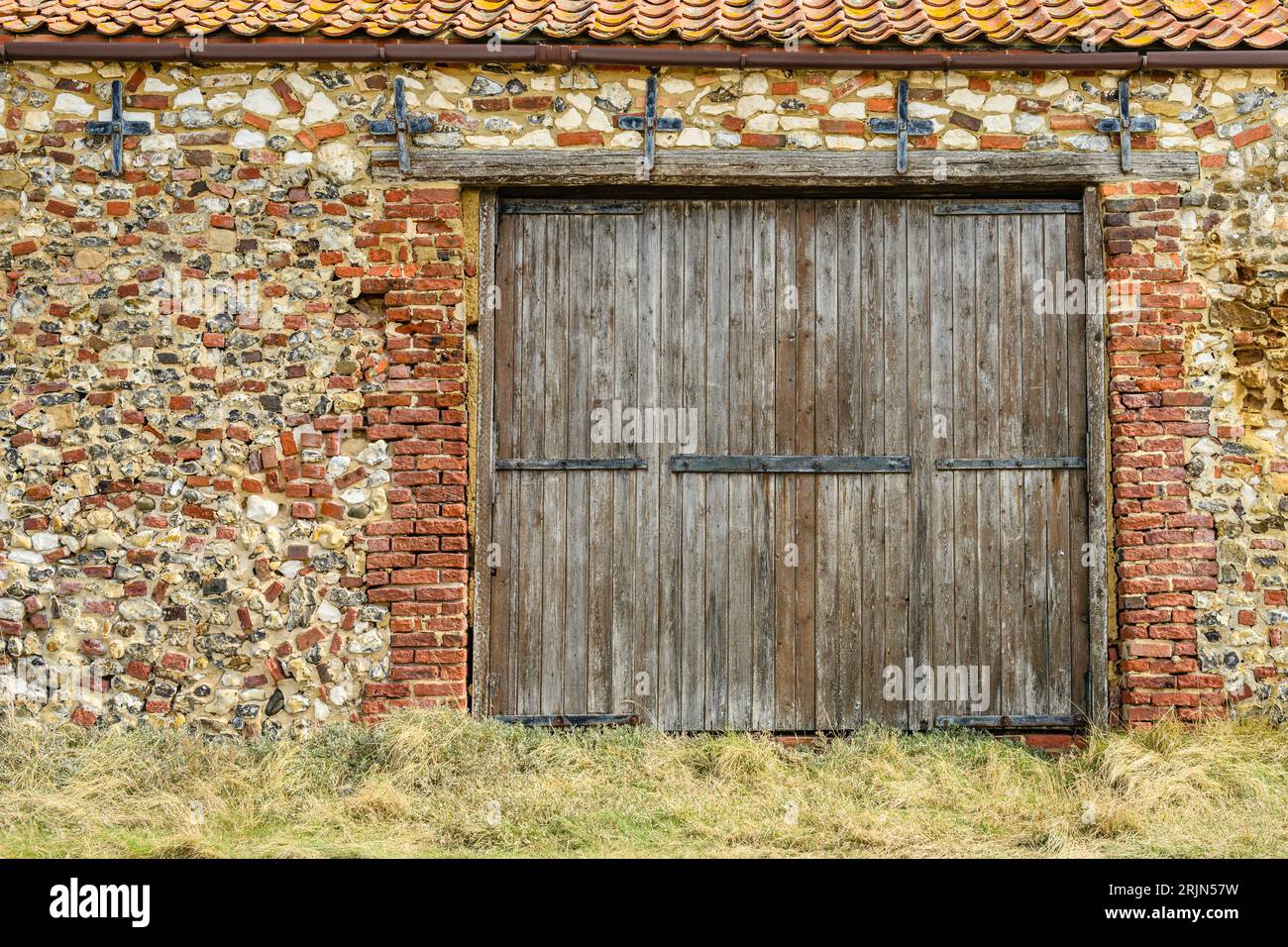 A traditional wooden door on an old rustic brick building with a ...