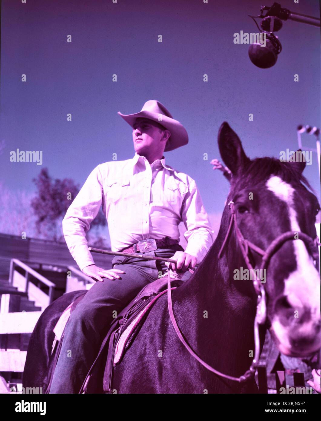 ROBERT MITCHUM on set location colour candid on horse by ALEX KAHLE ...