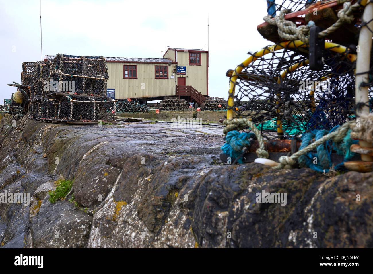 Framed by lobster traps, the St Abbs Independant lifeboat station ...