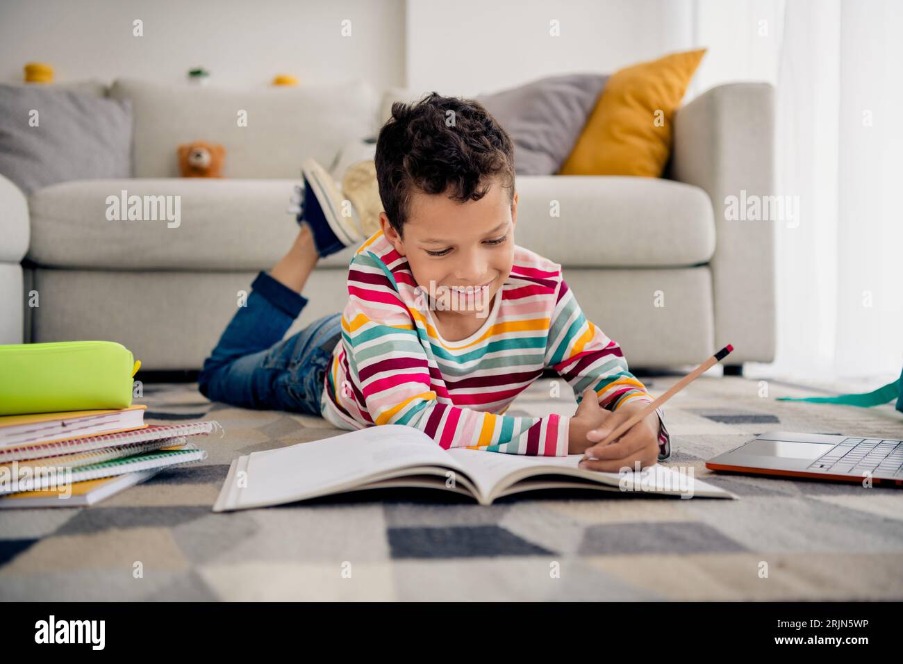 Full body size photo of lying home indoors schoolboy spend time on ...