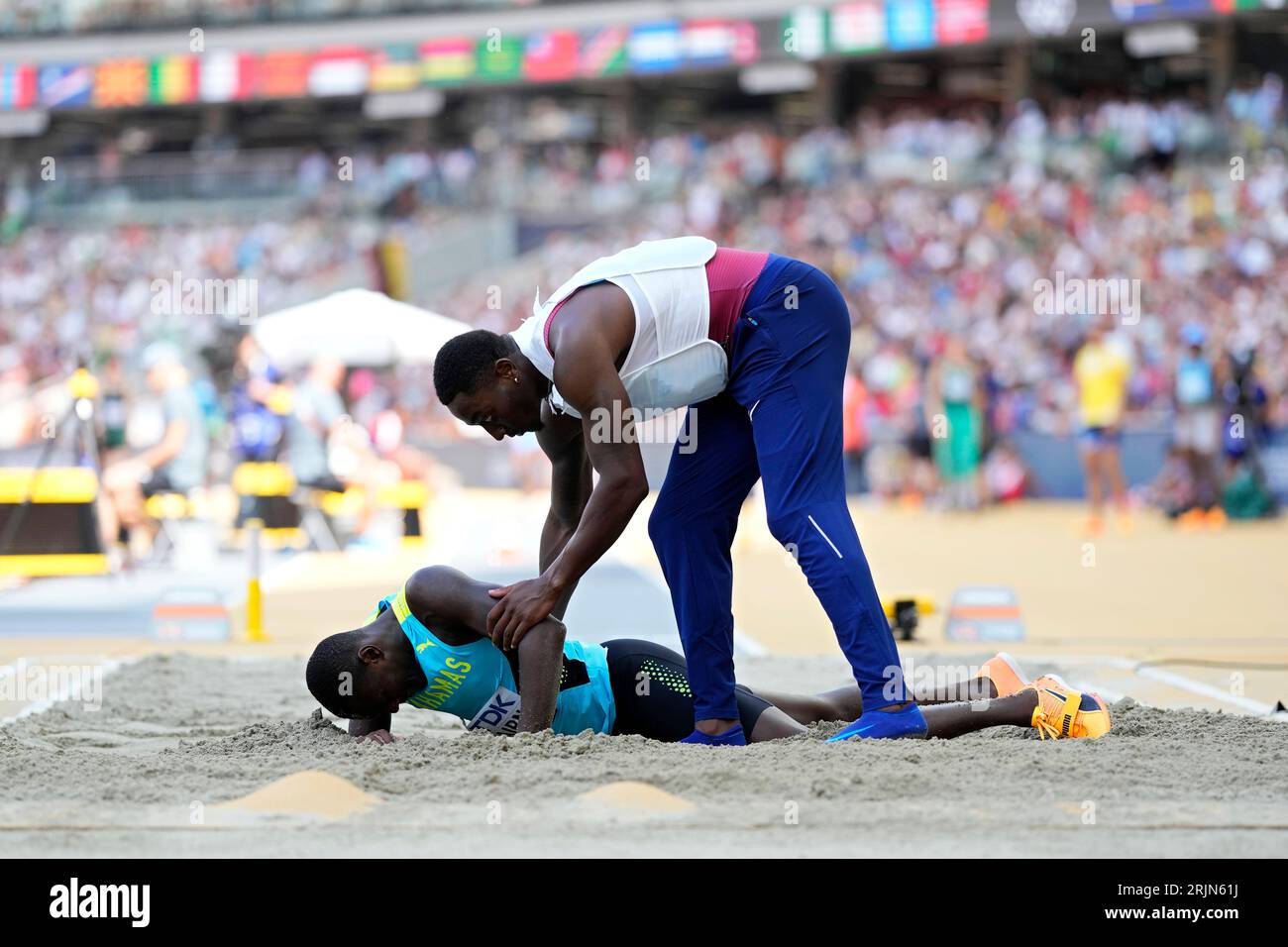 Terrence Jones, of Bahamas, is helped after injuring himself in an ...