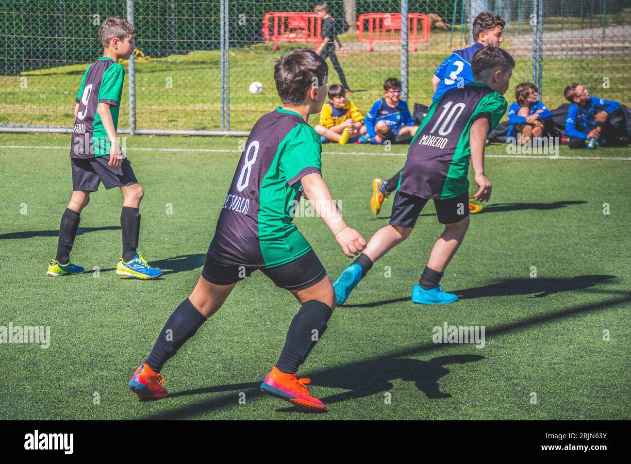 Children or kids playing football or soccer during a match on a ...