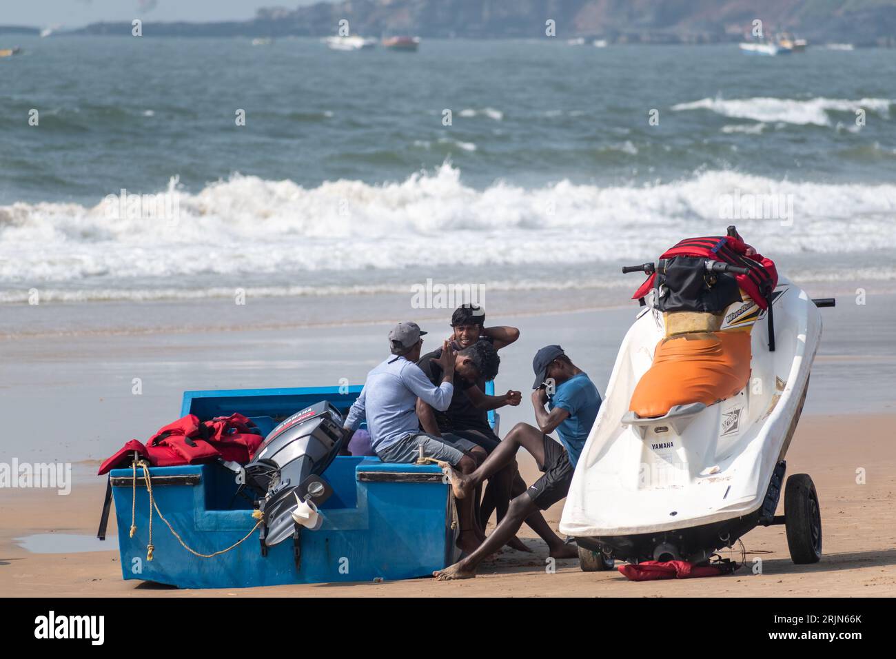 Calangute, Goa, India - January 2023: People sitting beside a jetski on ...
