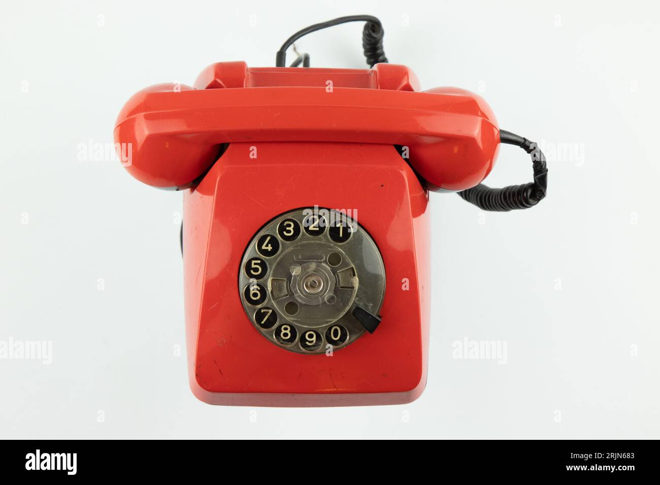 old Vintage red wine color telephone with a rotary dial isolated on ...