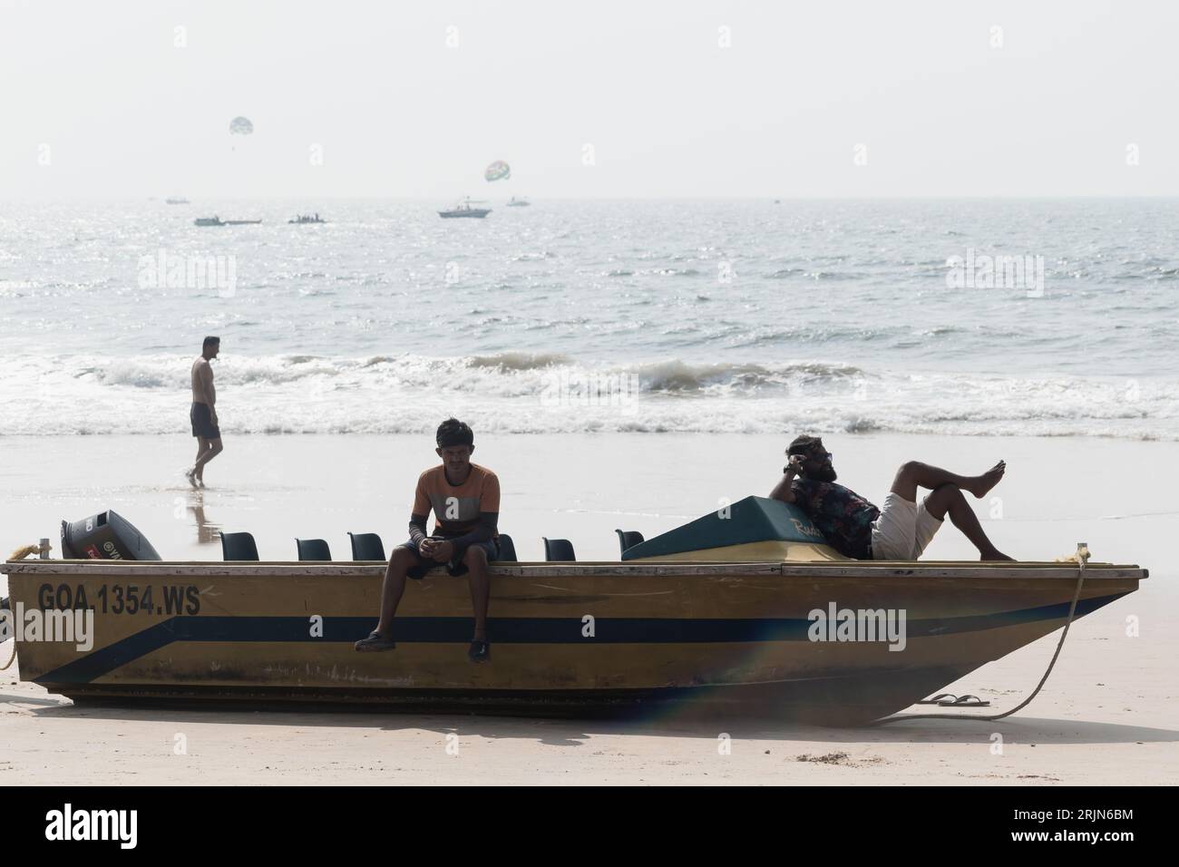 Calangute, Goa, India - January 2023: Men resting on an idle speed boat ...