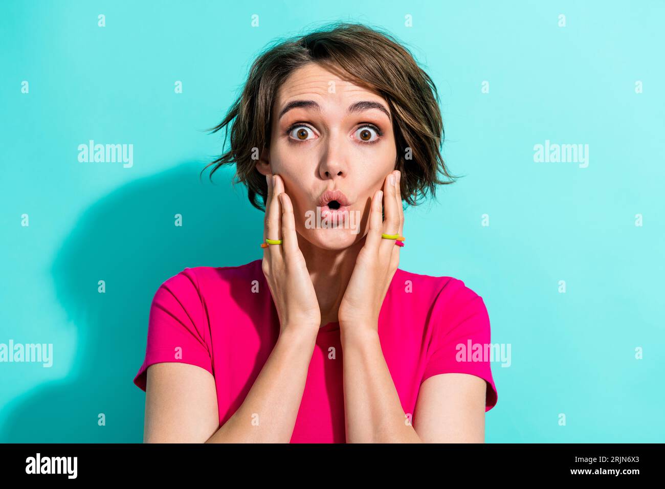 Portrait of impressed speechless person arms touch cheeks pouted lips ...