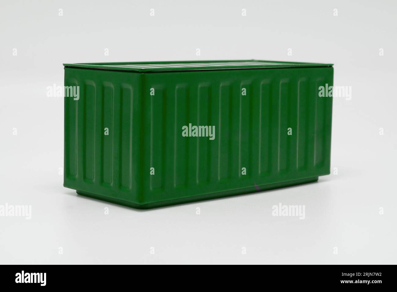 A close-up of a dark green shipping container against a white background Stock Photo - Alamy