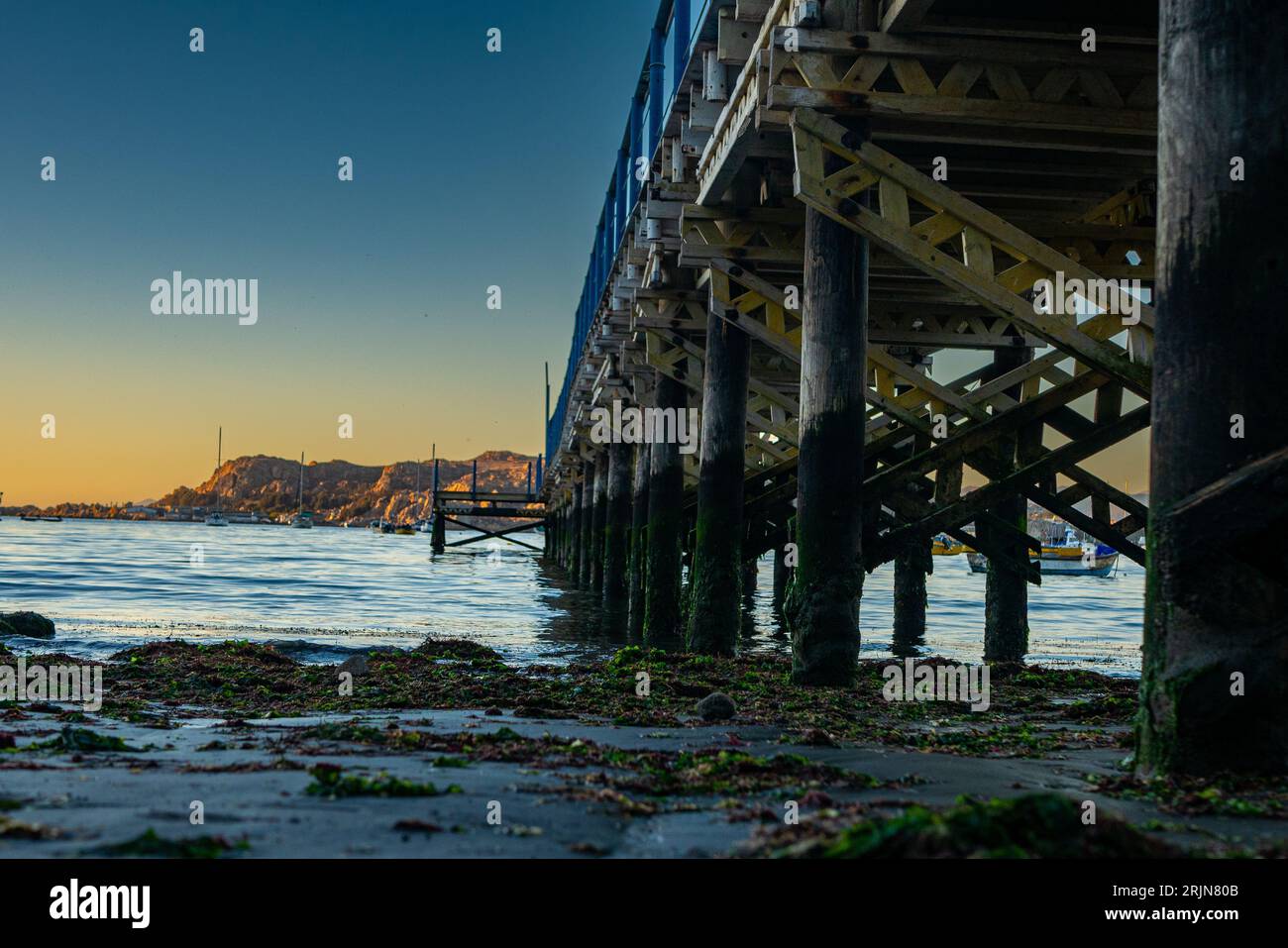 A wooden pier with tall posts on both sides of the structure, extending ...