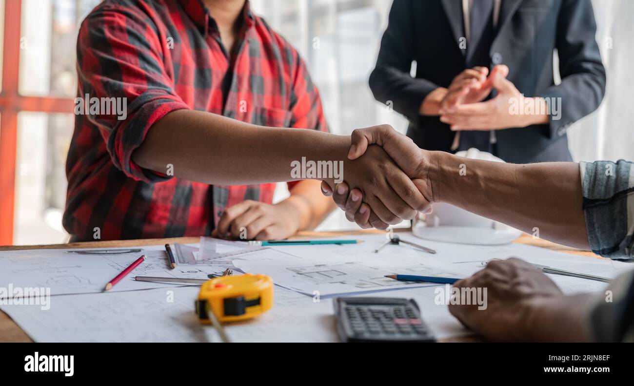 Engineer construction worker team handshake after consultation meeting ...