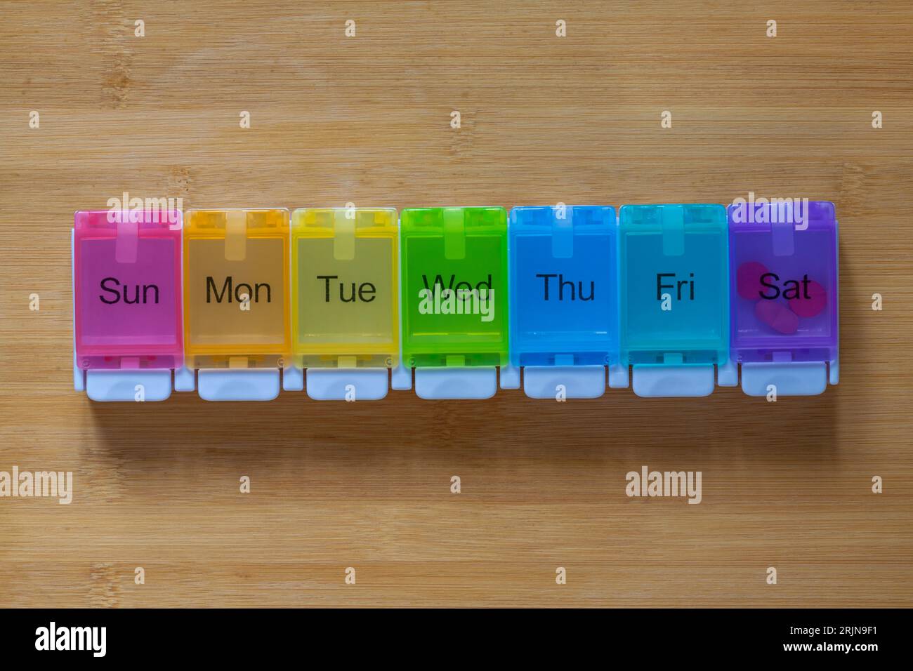 Daily pill box with different colours for different days of week to put ...