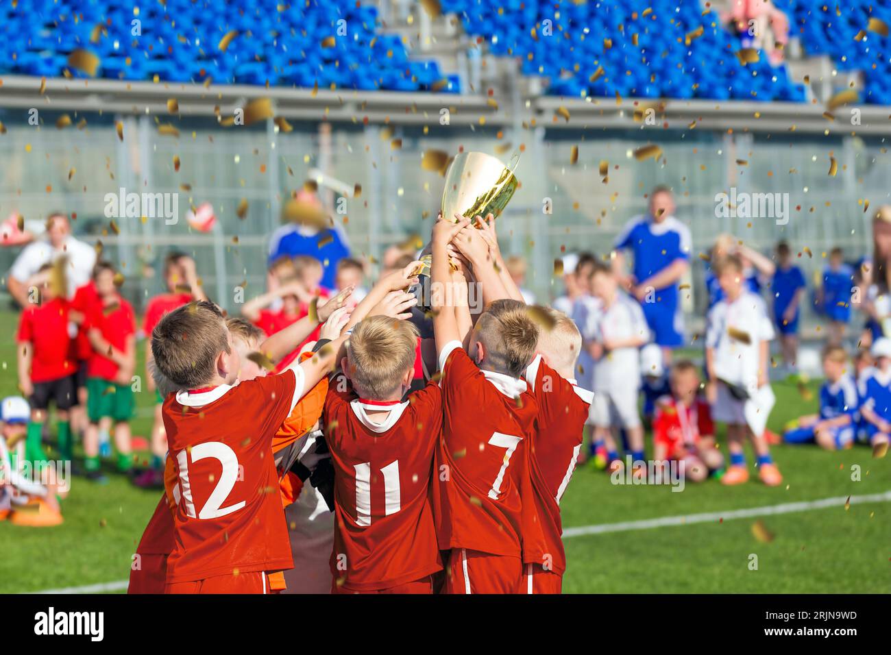 School Kids in Sports Team Winning Championship. Happy Children Holding and Rising Up Golden ...