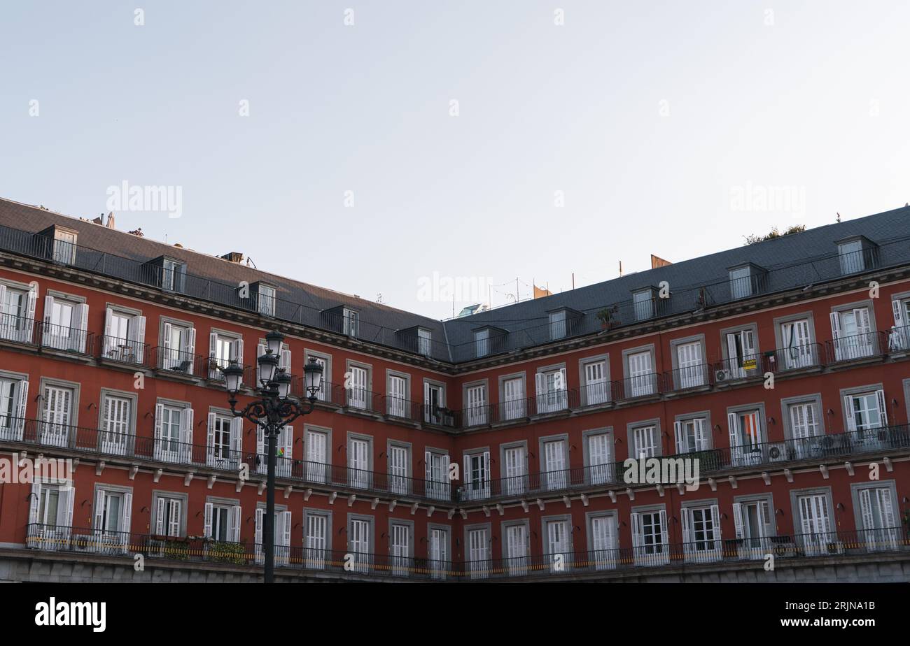 A majestic red brick building stands tall at the top of a street in ...