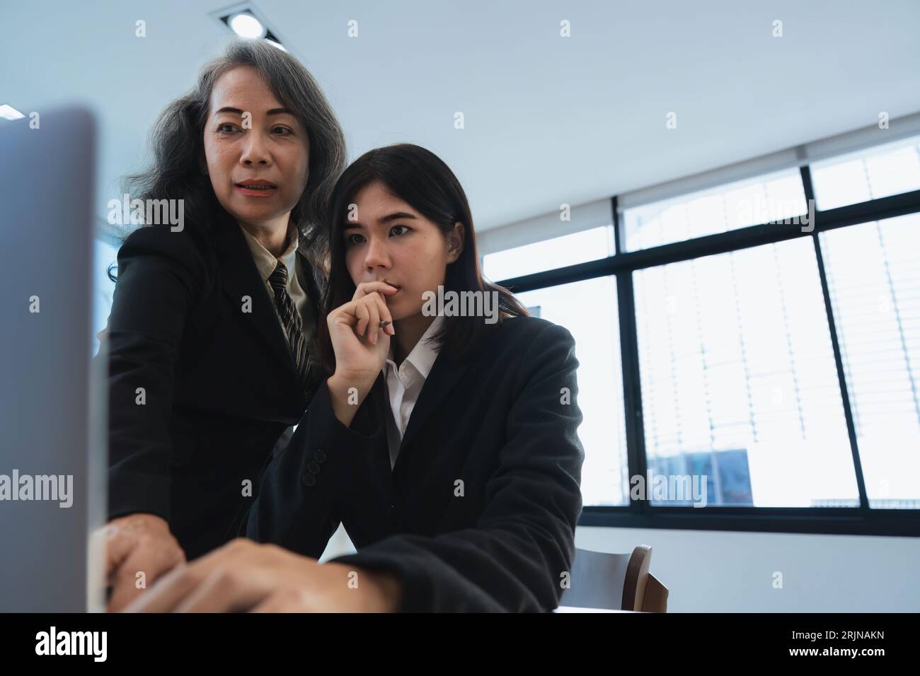 Teamwork collaboration senior manager explaining to an intern for ...