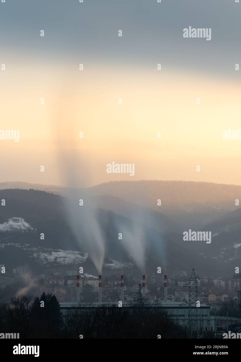 Smoke coming out of chimneys of heating plant at evening, Ponir ...