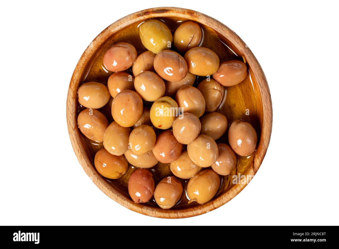 Scratched green olive at wooden bowl. Green olives isolated on white ...