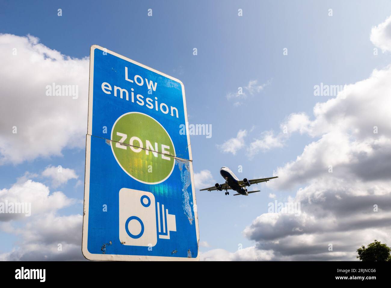 Low emission zone sign with jet plane landing at London Heathrow ...