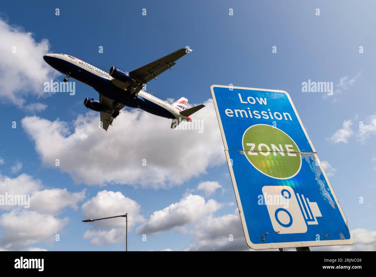 Low emission zone sign with jet plane landing at London Heathrow ...