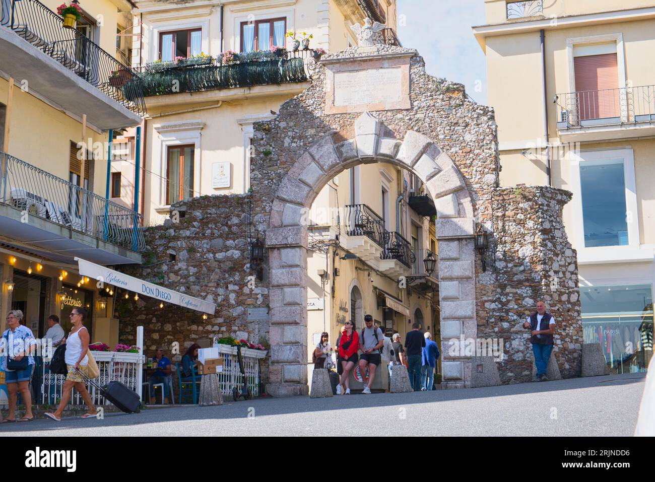 old city wall arched entrance to the old town in taormina, sicily ...