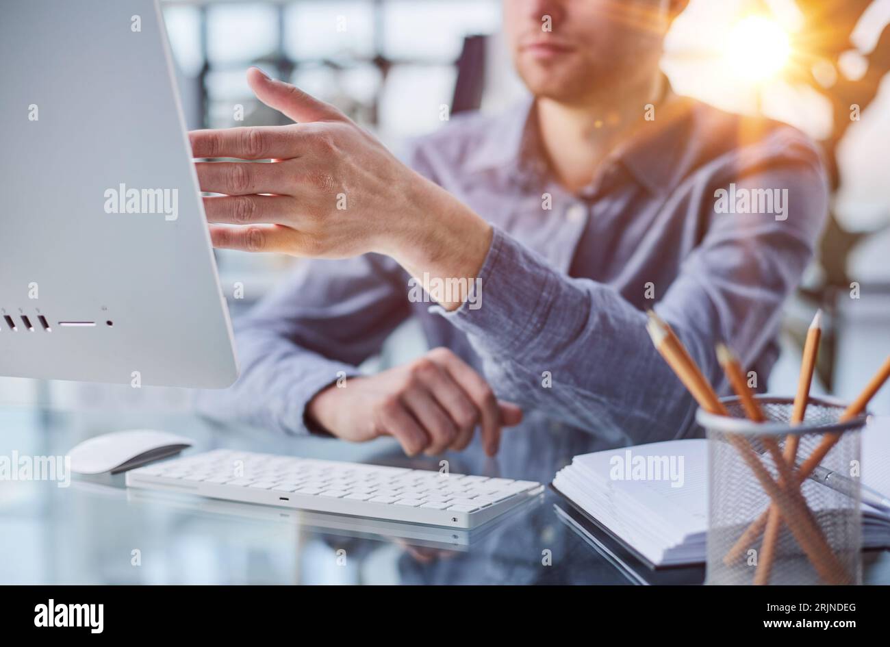 Person sitting at desk looking at pc hi-res stock photography and ...