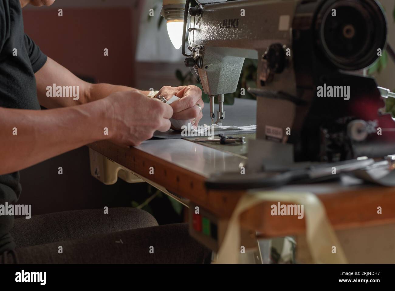 Woman sewing piece fabric hi-res stock photography and images - Alamy